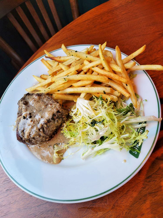 Steak frites done right&mdash;a perfectly cooked piece of beef alongside golden fries and a bright salad. The French really do understand the concept of balanced indulgence.