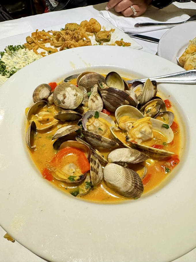 These clams aren't just swimming&mdash;they're doing synchronized laps in a broth so flavorful you'll be requesting extra bread for strategic dipping.