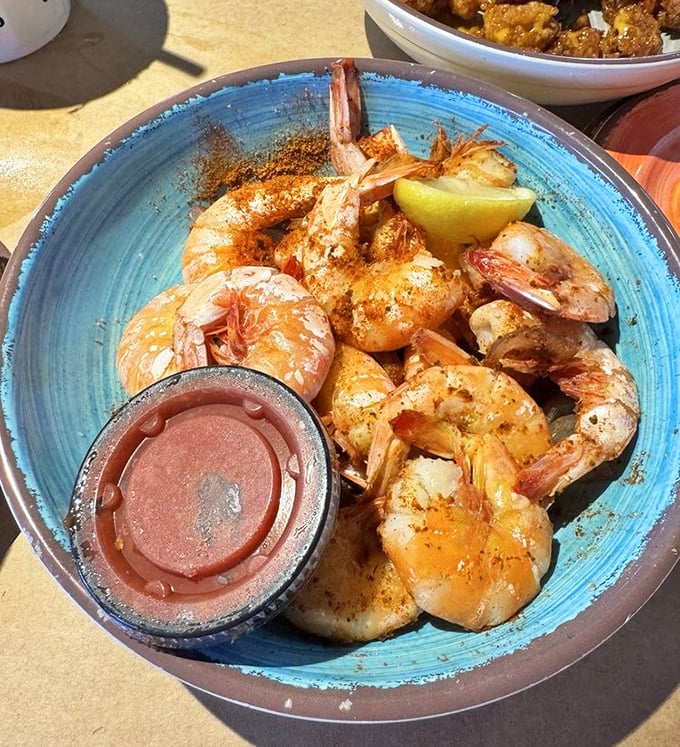 Peel-and-eat shrimp dusted with spices that would make your grandmother both blush and applaud. The lemon wedge isn't optional&mdash;it's essential chemistry.