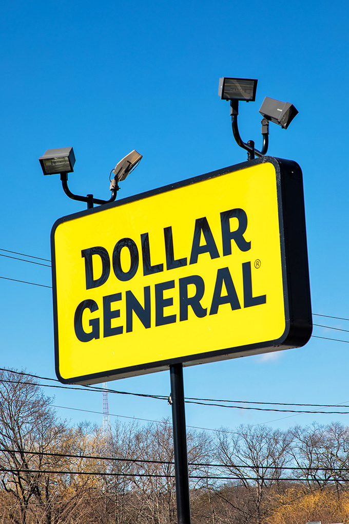 The Dollar General sign stands tall against the sky, a beacon of bargains visible from blocks away.