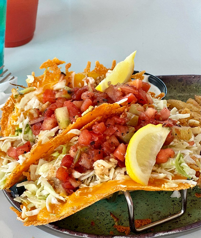 Taco architecture at its finest&mdash;where fresh cabbage, diced tomatoes, and jalape&ntilde;os create a colorful skyline above perfectly seasoned protein. Edible art.