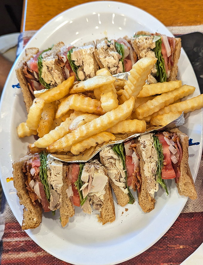A club sandwich built like a skyscraper of deliciousness. The architectural integrity alone deserves a standing ovation.