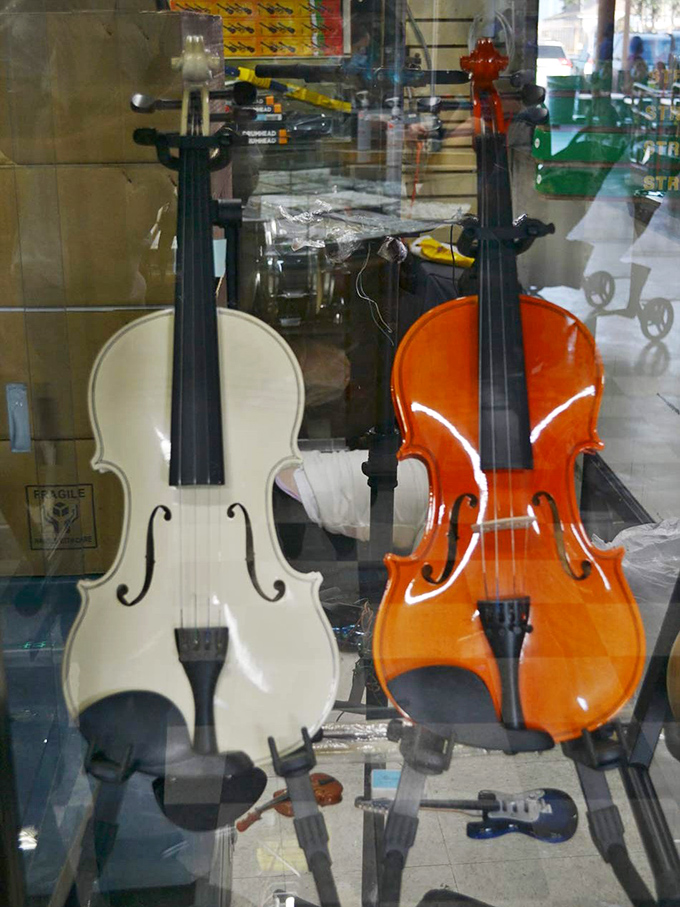 Classical beauty in white and orange. These violins aren't just instruments&mdash;they're gateways to cultural expression waiting for the right hands.