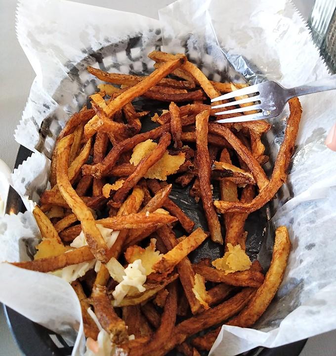 Sweet potato fries piled high enough to make you forget every diet resolution you've ever made.