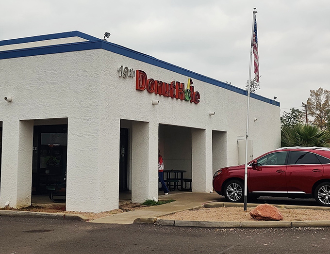 The patriotic flag waves proudly above this classic American donut shop in Mesa. 