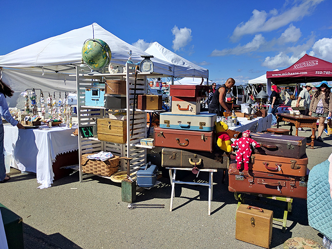 Colorful vintage suitcases stack like rainbow building blocks from a more elegant traveling era.