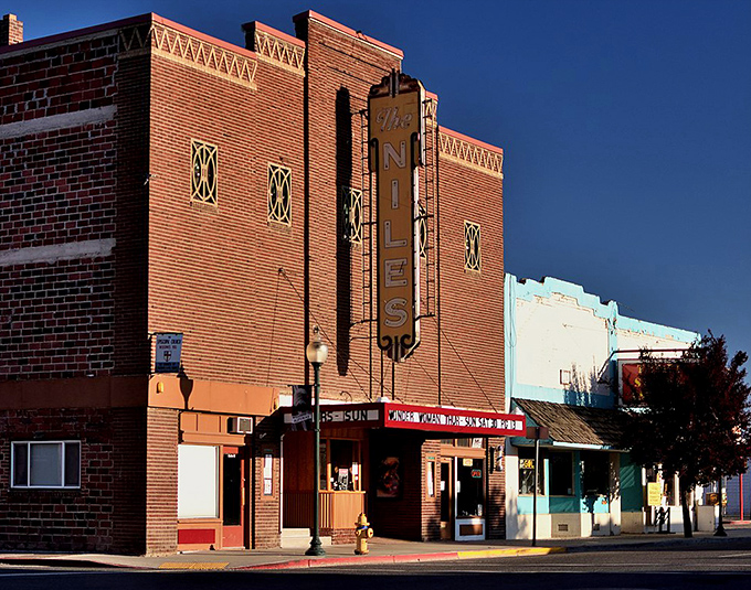Showtime nostalgia! The Niles Theatre's brick facade and vintage vertical sign transport you to when movies cost a nickel and popcorn wasn't a second mortgage.