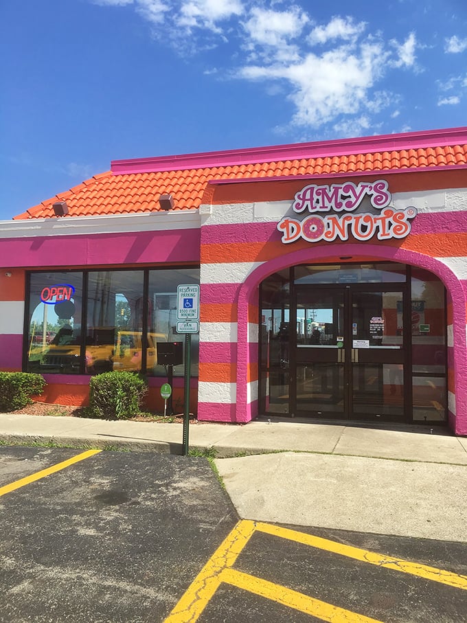 That vibrant pink and orange exterior promises the kind of fun that only comes with seriously delicious donuts.
