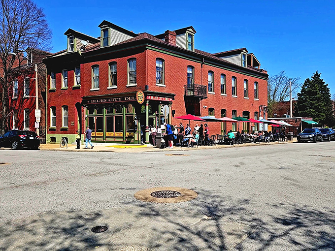 Historic brick buildings and red umbrellas create the perfect stage for St. Louis sandwich theater to unfold.