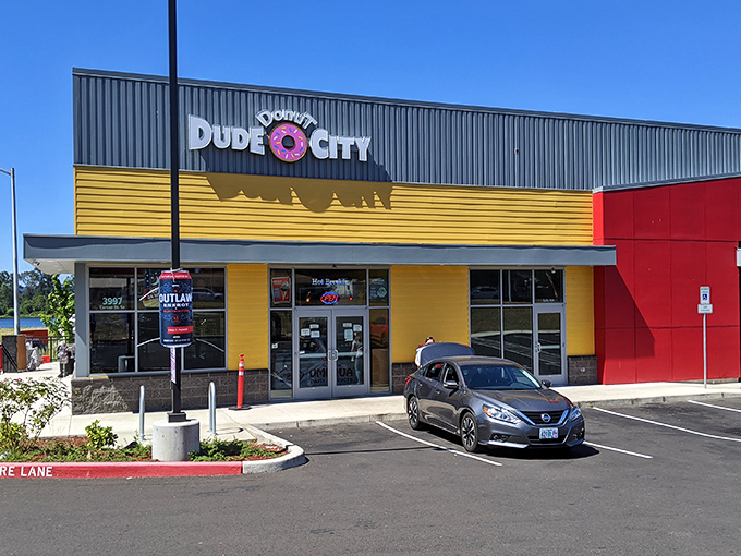 Dude Donut City's bright yellow facade stands out like a sunrise, promising a day that starts with sweet satisfaction.