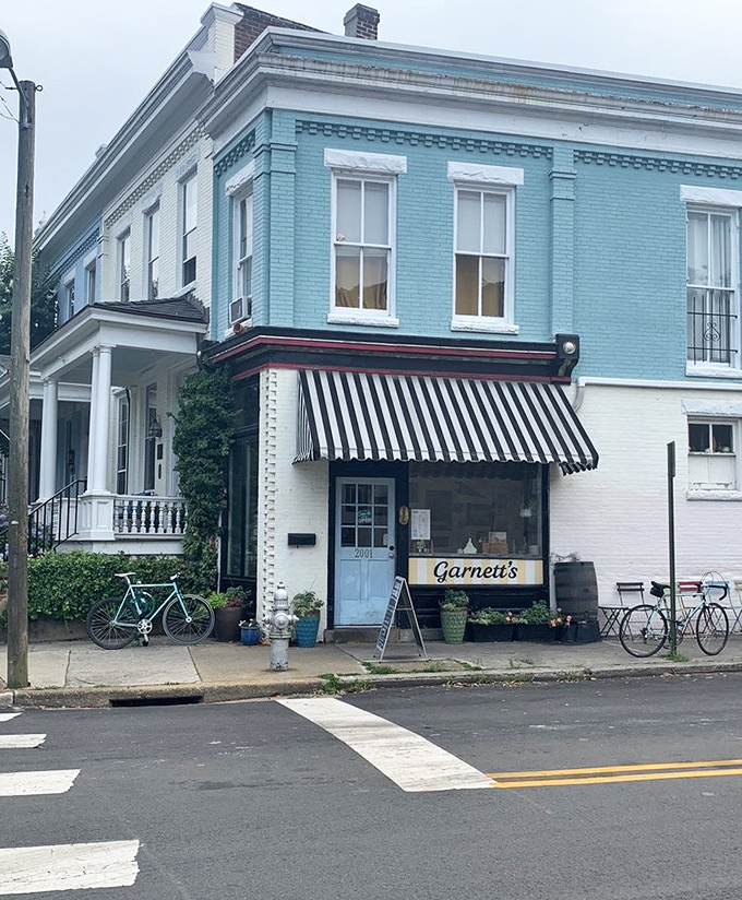Garnett's teal corner building with classic black and white awning looks like it should be in a Wes Anderson film about sandwich perfection.