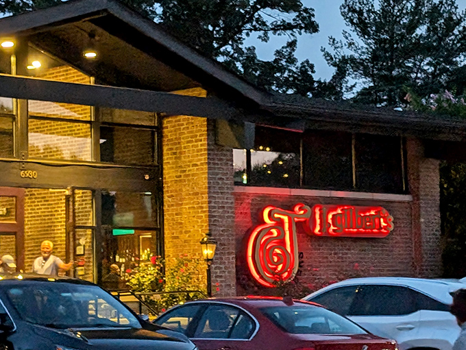 J. Gilbert's neon signature glows like a lighthouse, guiding hungry travelers to wood-fired perfection.