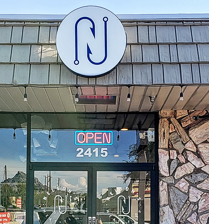 Nelson's sleek circular logo hints at the precision and quality waiting behind those modern glass doors.