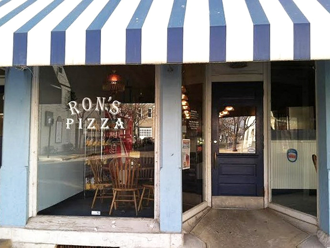 Blue and white stripes never looked so inviting - small town charm meets serious pizza craft.