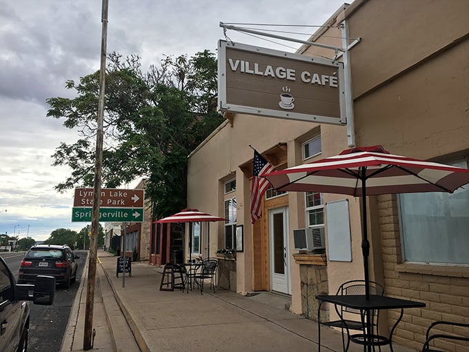 The Village Cafe in St. Johns serves up small-town charm under striped umbrellas, where coffee costs less than your daily horoscope subscription.