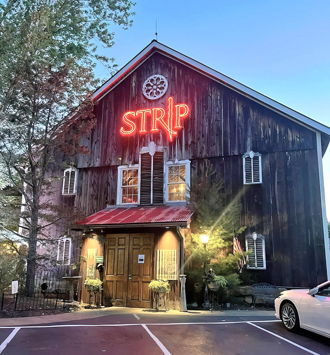 The Strip Steakhouse barn glows at dusk &ndash; part rustic time capsule, part carnivore's dream come true.