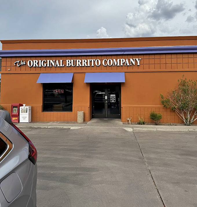 The Original Burrito Company's vibrant orange building stands out like their flavors. Bold, unapologetic, and impossible to ignore!