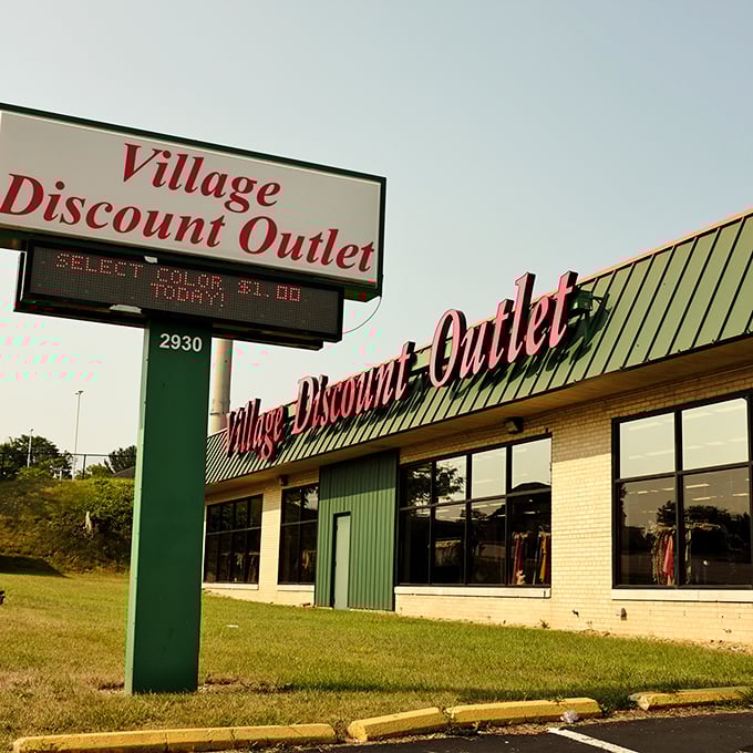 Village Discount Outlet's vintage sign and sprawling storefront promise adventures in affordable shopping await within.
