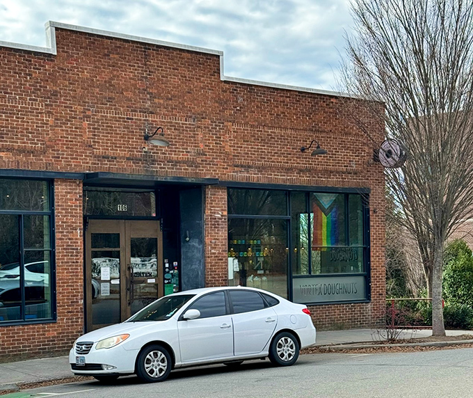 Modern brick meets creative spirit in this bright space where donut innovation happens behind those welcoming windows.
