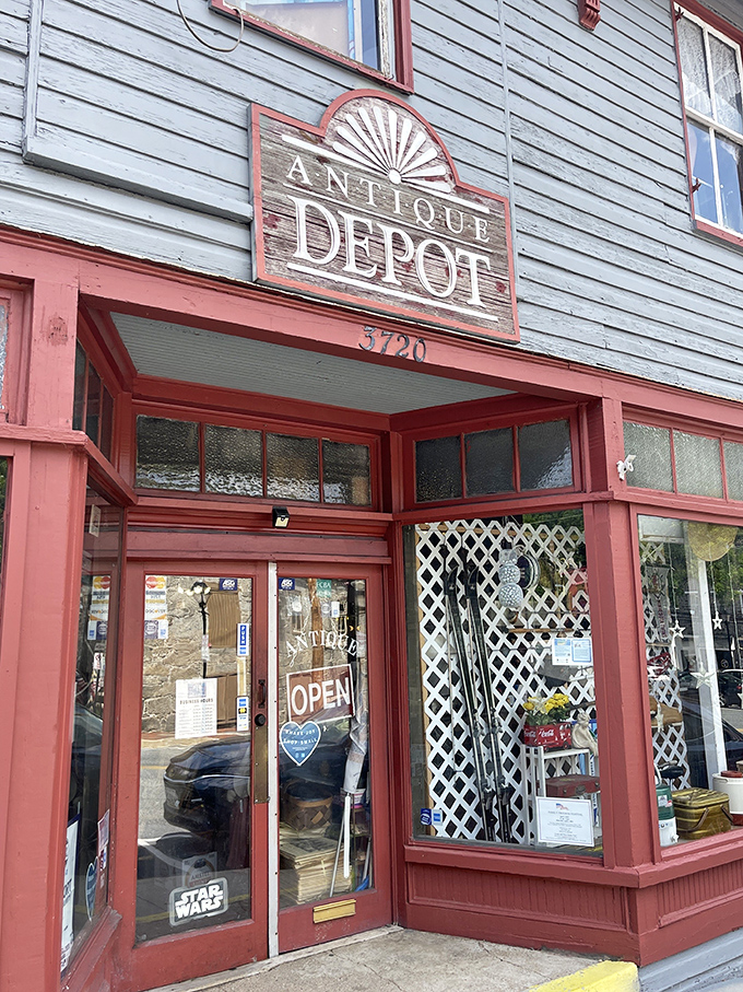 Peek through these windows into yesterday's treasures at Antique Depot. The vintage sign and red trim create the perfect frame for antiquing adventures.