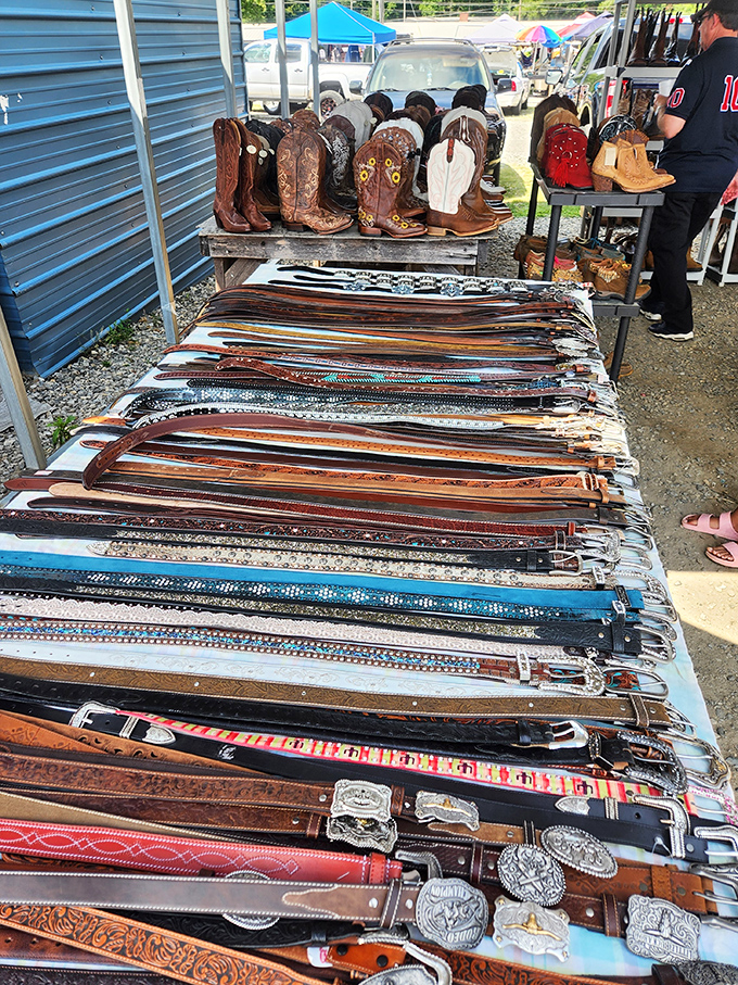 Cowboy boots and leather belts line this vendor's display &ndash; the perfect spot for Western wear enthusiasts.