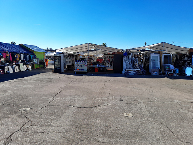 The classic flea market experience lives on! Tents and tables create temporary retail neighborhoods under clear blue skies.