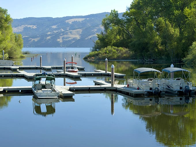 Boat slips and mountain reflections create the kind of lakeside living that used to exist everywhere.