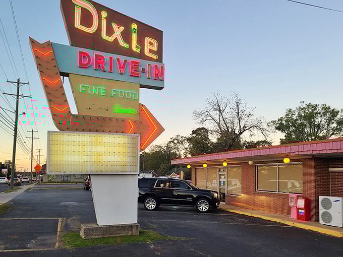 That vintage neon sign practically glows with decades of satisfied customers and perfectly grilled burgers.