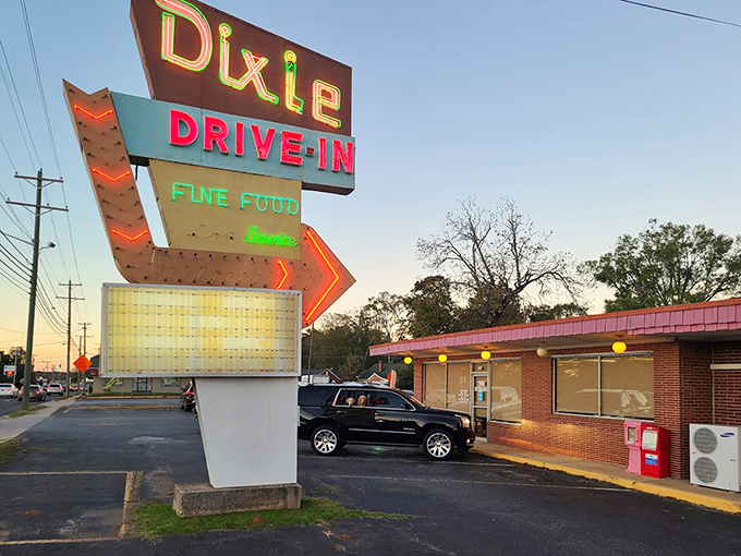 That vintage neon sign practically glows with decades of satisfied customers and perfectly grilled burgers.