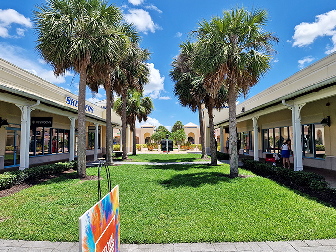 Palm trees frame your path to savings. Shopping feels more exotic when the buildings look this good.