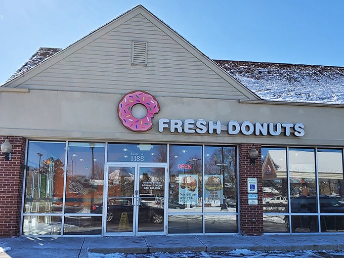 Winter can't dim the appeal of Fresh Donuts' welcoming storefront. That pink donut sign is like a warm hug on a cold day.