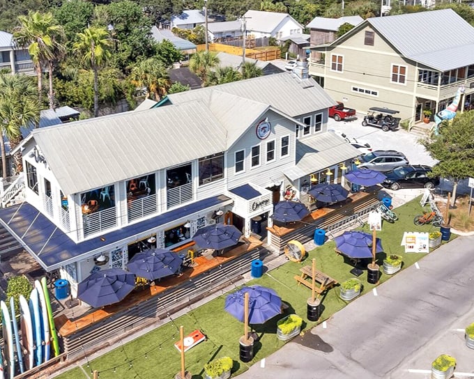 Grayton Beach's colorful community hub buzzes with locals and lucky visitors. Blue umbrellas invite you to stay awhile and savor coastal flavors.
