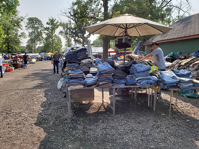 Tables of clothing and household goods create an outdoor department store atmosphere at Greenlawn Grove's market.