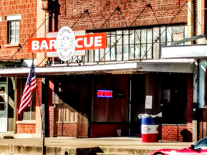 That classic red, white, and blue sign represents Texas barbecue royalty in its most authentic form.