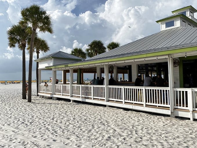 Beach history on display! Palm Pavilion has welcomed sun-seekers since the Roaring Twenties, serving up grouper sandwiches with a side of nostalgia.