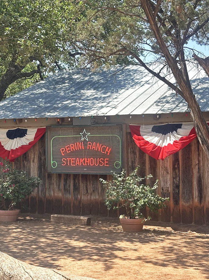 Red, white and blue bunting frames the entrance to beef nirvana. Perini's weathered wood exterior has welcomed hungry Texans for generations.