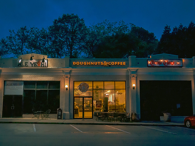 Evening glow transforms this modern donut shop into a beacon for adventurous taste explorers.