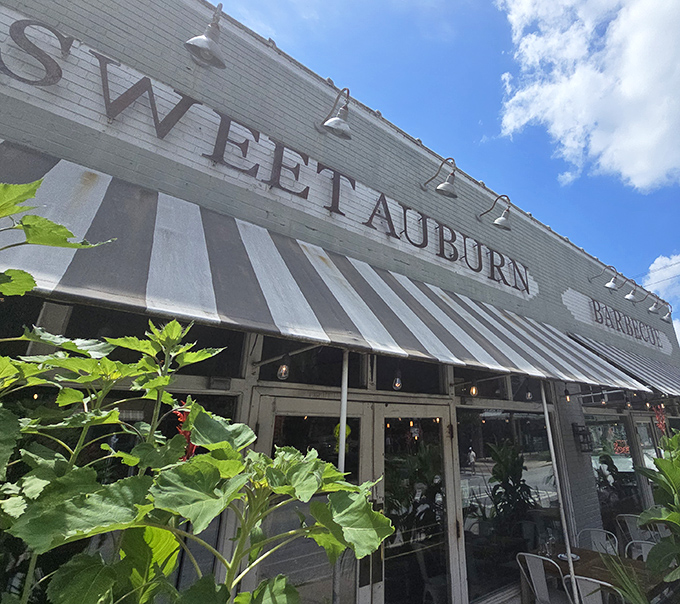 Those striped awnings frame windows into a world where traditional smoking techniques create modern-day magic.