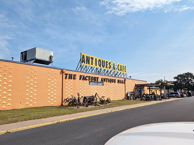 Old farm equipment decorates the perimeter, hinting at the rural treasures waiting inside this massive antique wonderland.