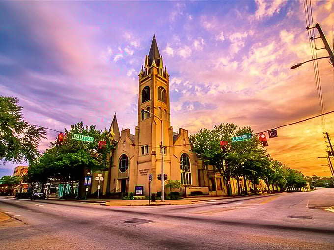 Valdosta's church spire reaches dramatically skyward, catching the sunset's glow like nature's own spotlight.