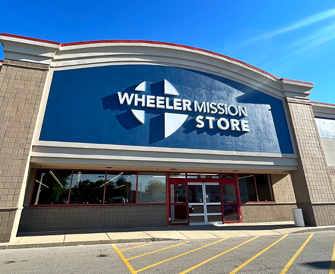 The Wheeler Mission Store's distinctive blue signage with cross emblem makes a bold statement. This Fishers location promises both bargains and purpose.