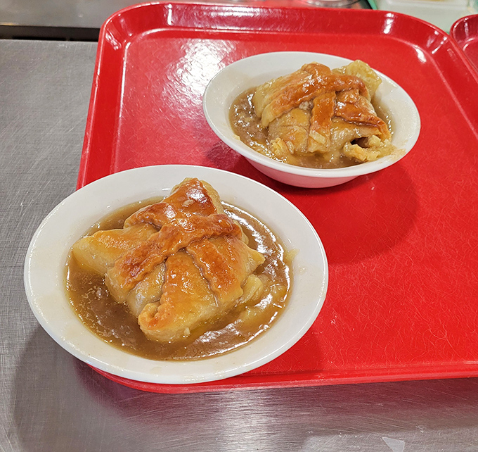 These apple dumplings swimming in caramel sauce aren't just dessert&mdash;they're edible time machines to simpler days. Calories? We're not counting today.