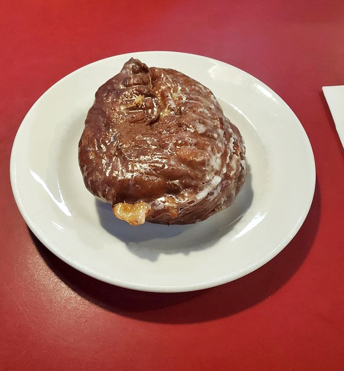 This apple fritter isn't just a pastry, it's a glistening monument to the beautiful relationship between dough and glaze.