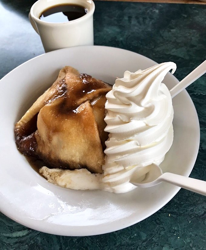 This apple dumpling with its cloud of whipped cream isn't dessert &ndash; it's what angels eat when nobody's looking. Coffee mandatory for the full experience.