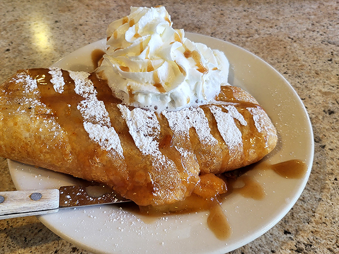Apple pie that deserves its own zip code. That caramel drizzle and whipped cream topping aren't just garnishes&mdash;they're essential supporting characters in this dessert drama.