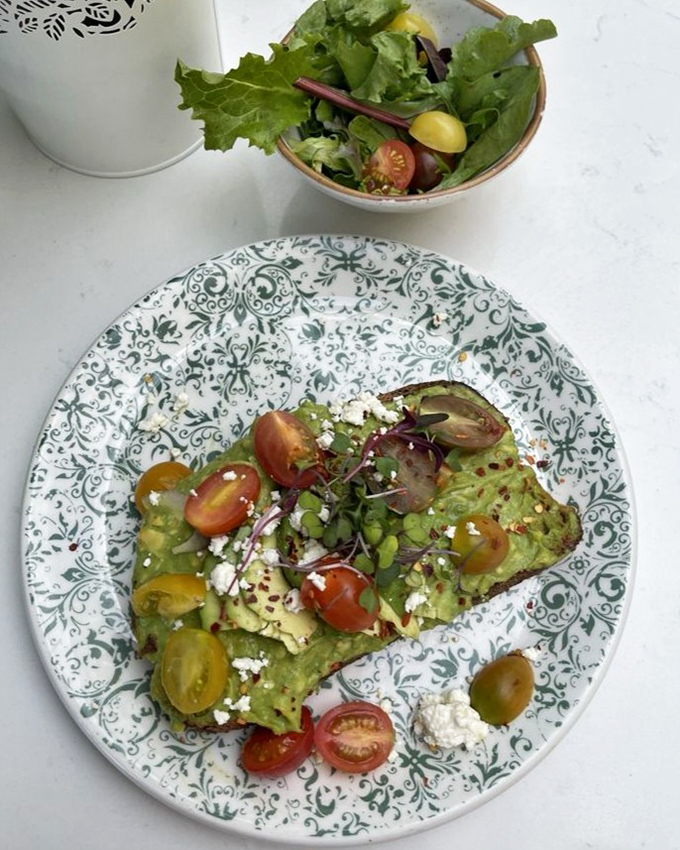 This avocado toast isn't just Instagram-worthy&mdash;it's a masterclass in texture with creamy avocado, crunchy seeds, and those vibrant tomatoes stealing the spotlight.
