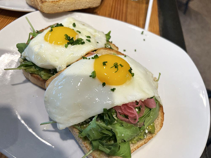 Avocado toast gets the smokehouse treatment with sunny-side-up eggs that stare back at you saying, "You know you want this."