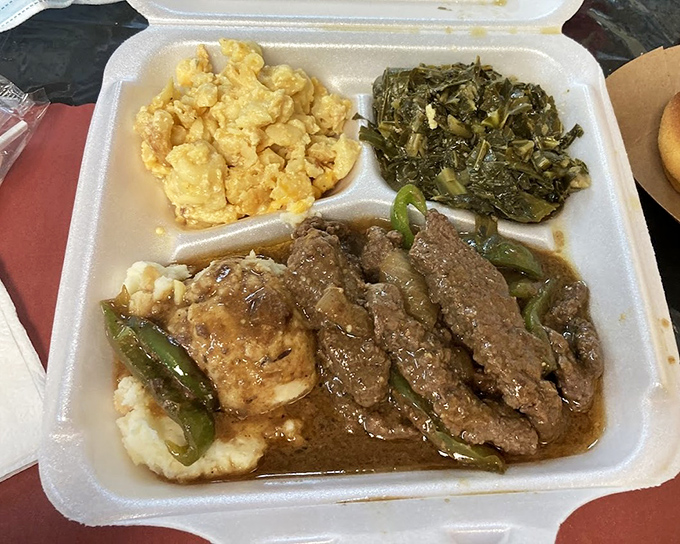 When meat, gravy, and sides come together like this, it's not just a meal - it's a symphony of Southern comfort on a humble takeout plate.