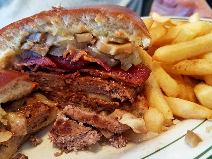 When a burger and bacon fall in love, this is their wedding portrait. The kind of sandwich that requires a strategy session before the first bite.