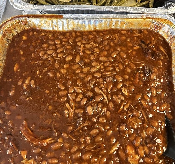 These aren't your cafeteria baked beans. They've been simmering so long they're practically paying rent in that sauce.